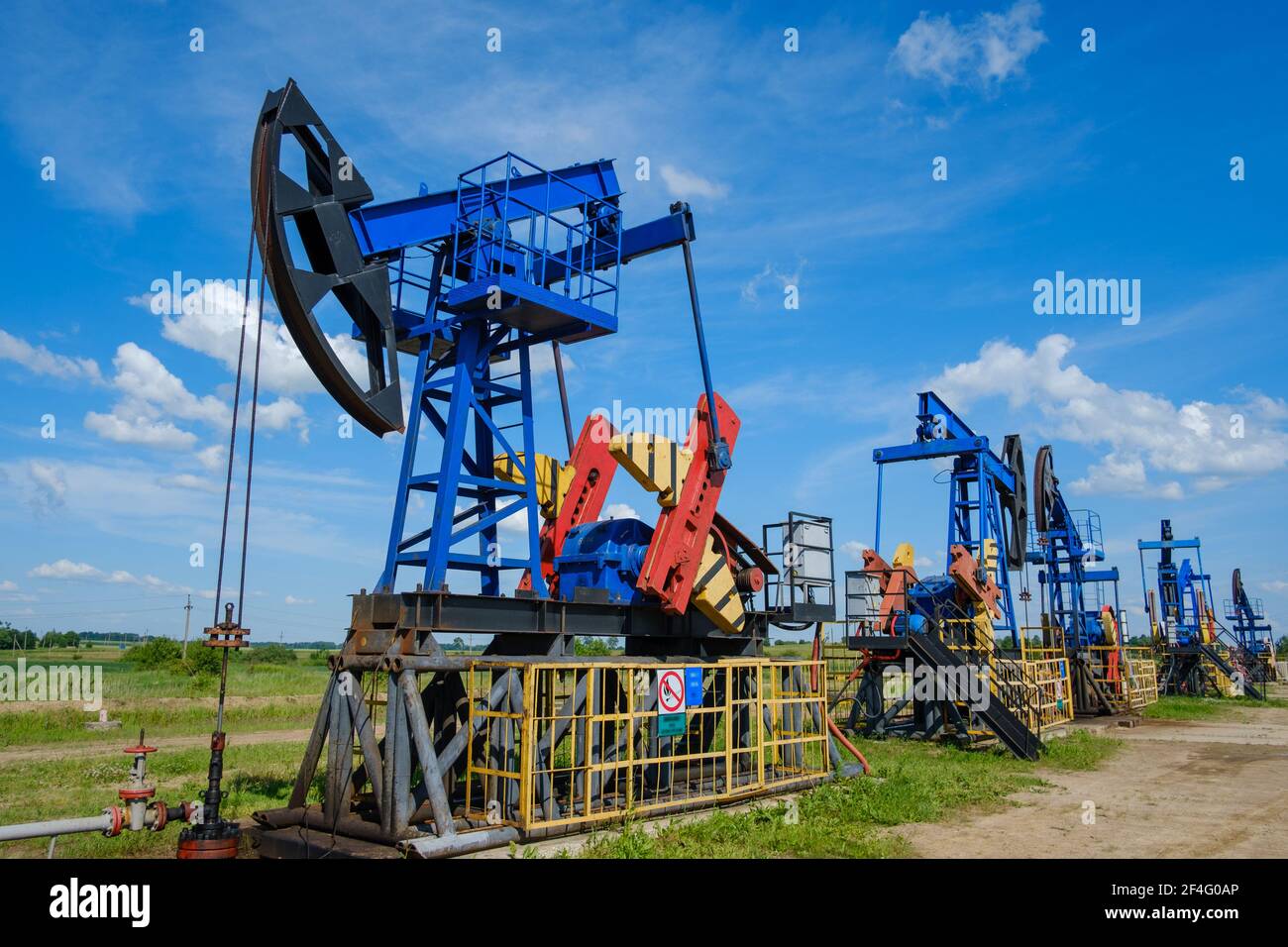 Oil pumps against cloudy sky Stock Photo - Alamy