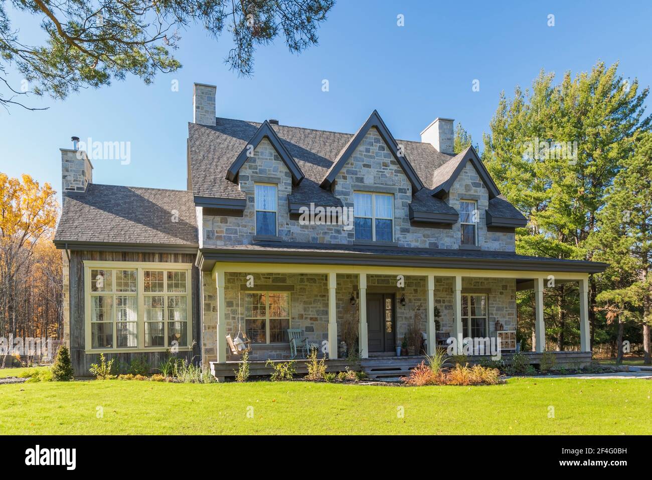 Tan, beige and grey nuanced natural cut stone and barn wood cladded ...