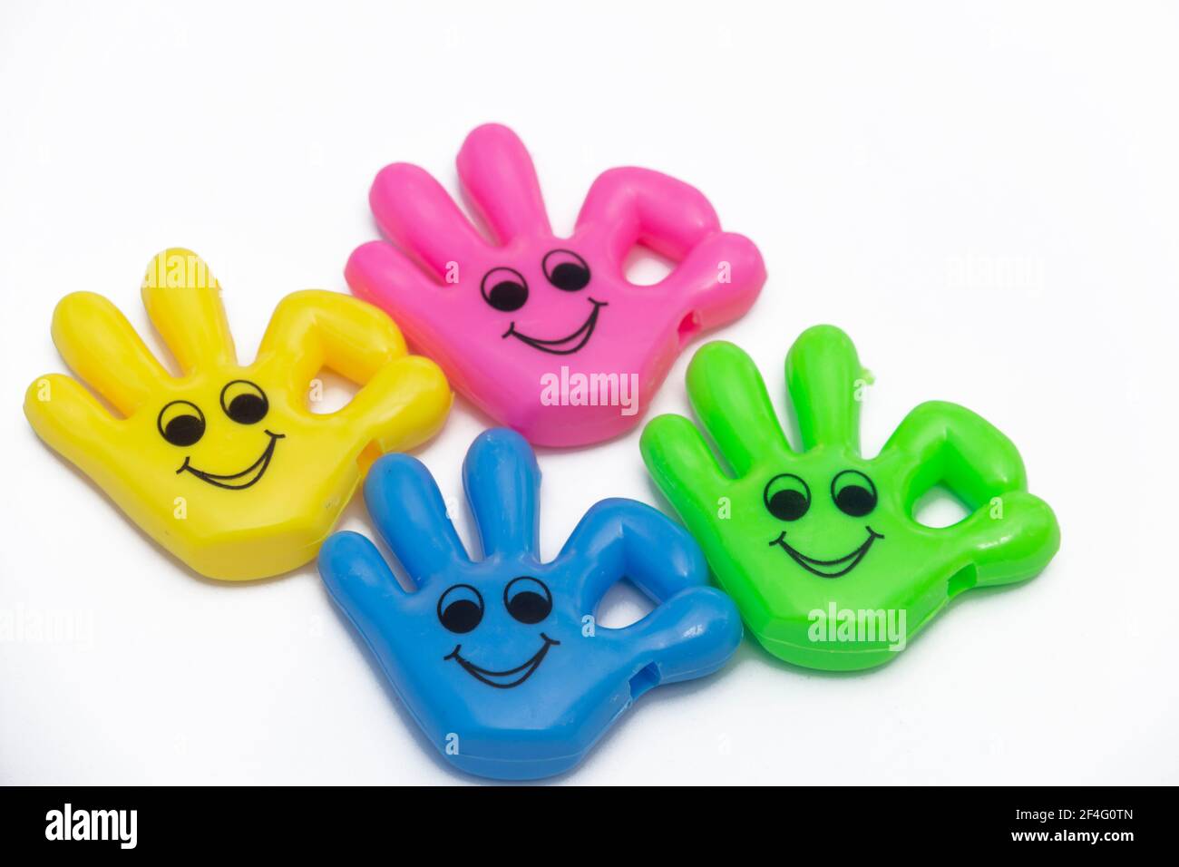 Small plastic hands with smile on face making the OK sign isolated on ...