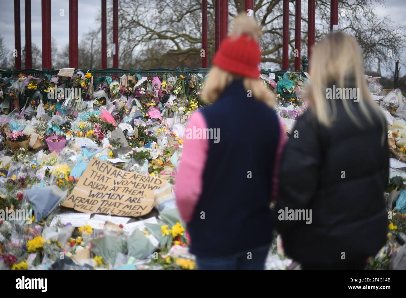 People viewing floral tributes left at the bandstand in Clapham Common ...