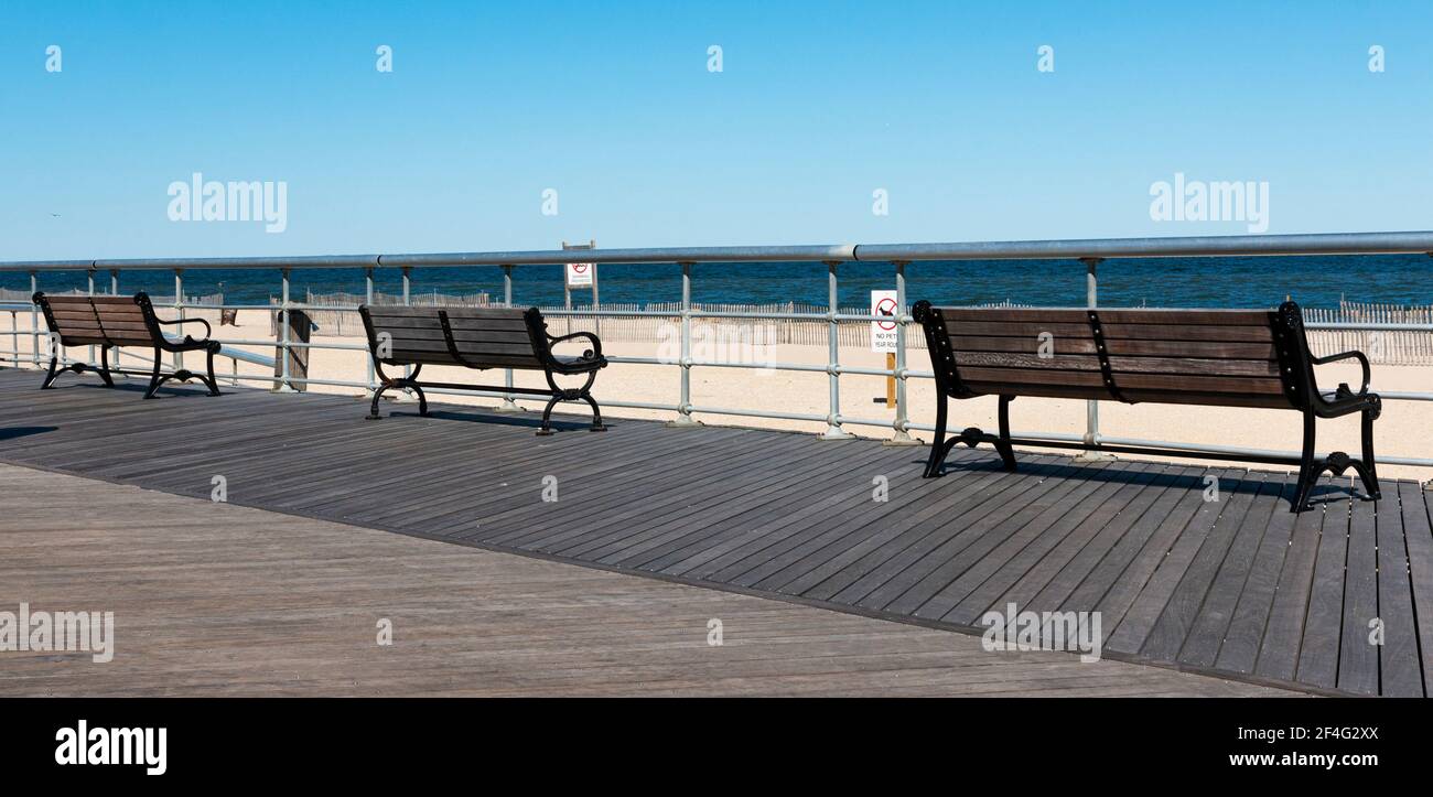 Three park benches on the boardwalk at Sunken Meadow State Park looking ...