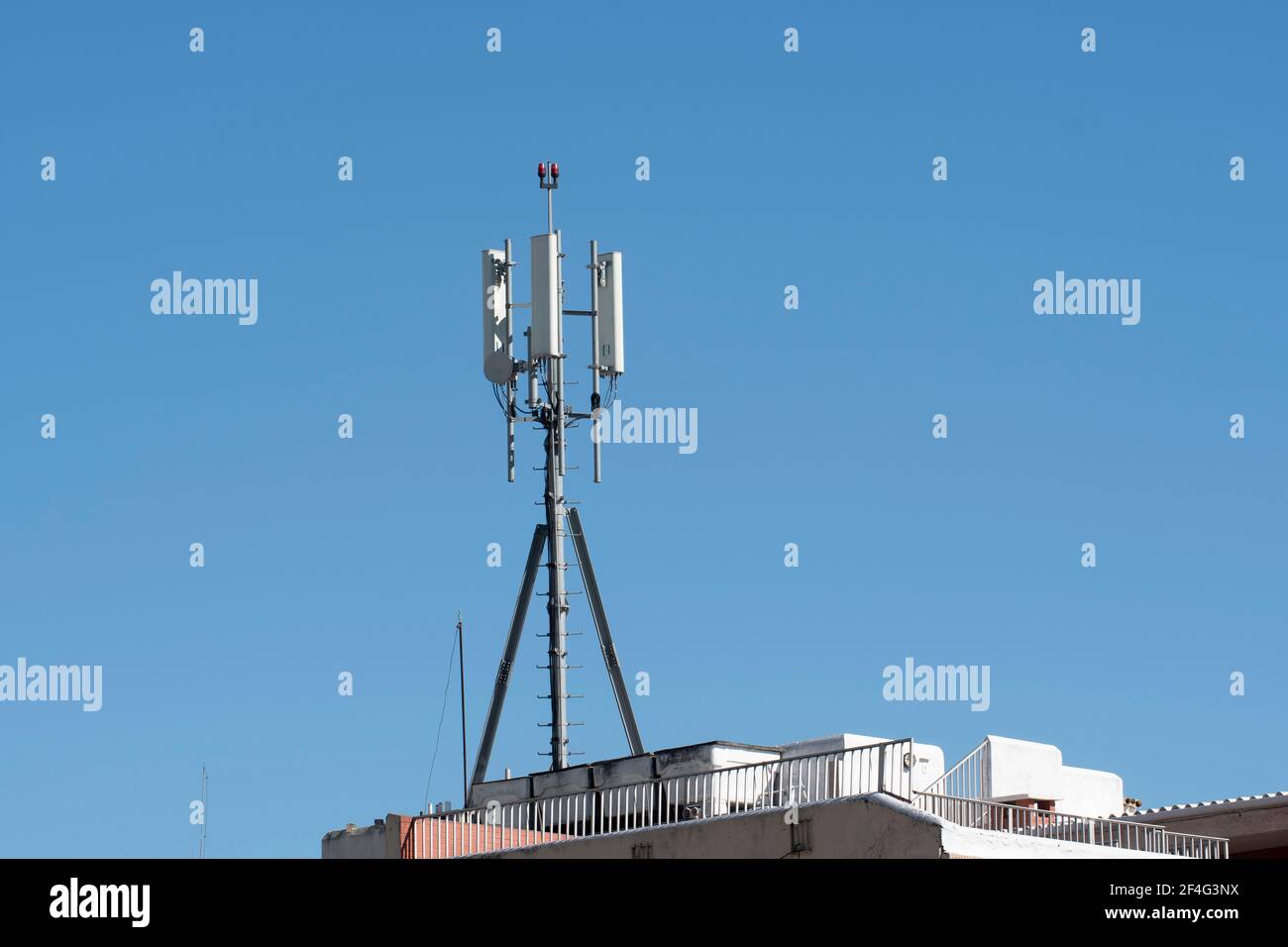 Cellular transmitters on top of building with a blue sky morning Stock ...