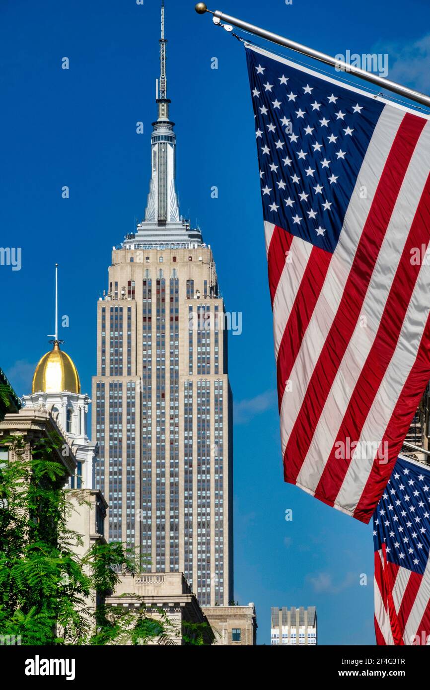 The iconic Empire State Building is viewed with an American flag on ...