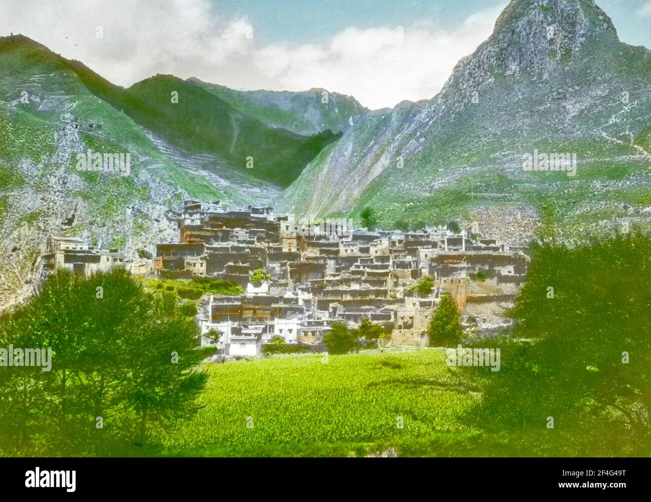 Wide shot, on a sunny day, of a stone-built Jiarong Tibetan village ...