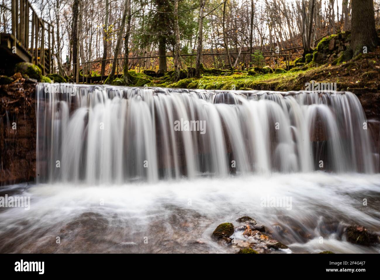 Waterfalls of Ieriku nature park at old watermill in the forest. It's a ...