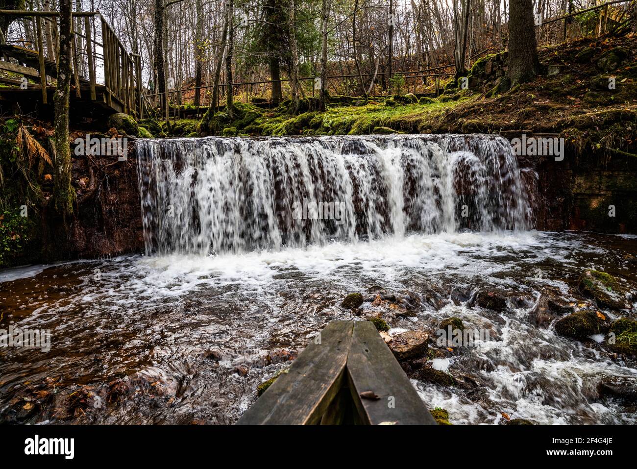 Waterfalls of Ieriku nature park at old watermill in the forest. It's a ...