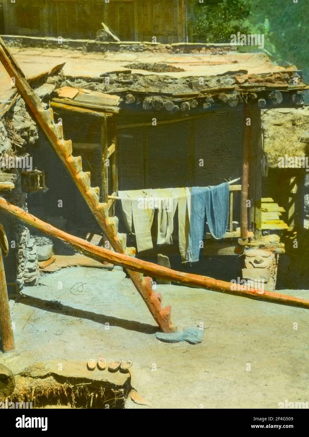 High angle view of a rough-built house with laundry hanging on a pole ...