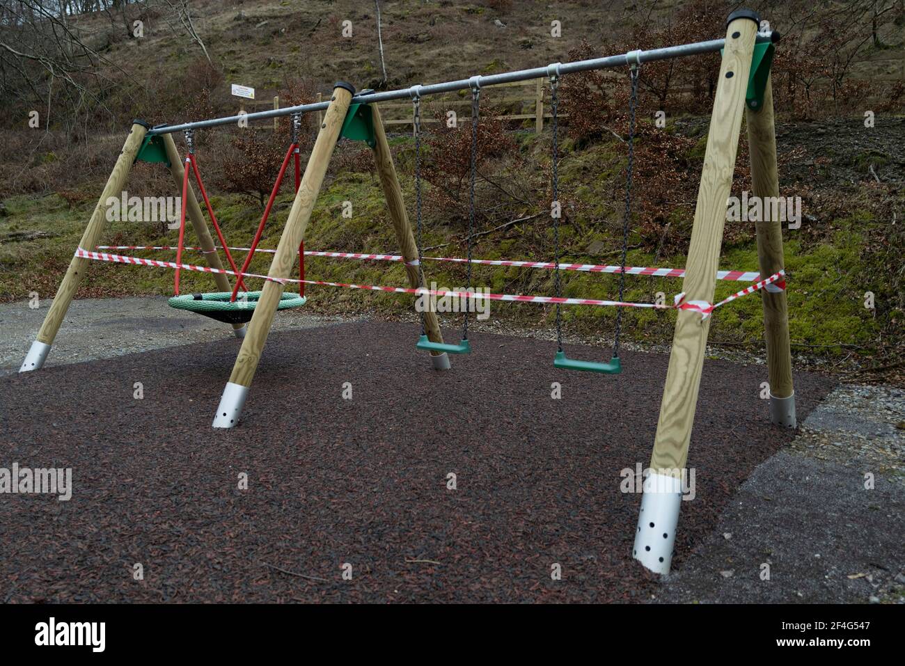 Swings in an outdoor play area taped off during the coronavirus ...