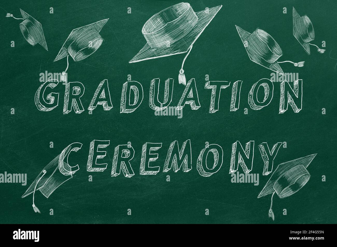 Hand drawing text "Graduation ceremony" and graduation caps on green ...