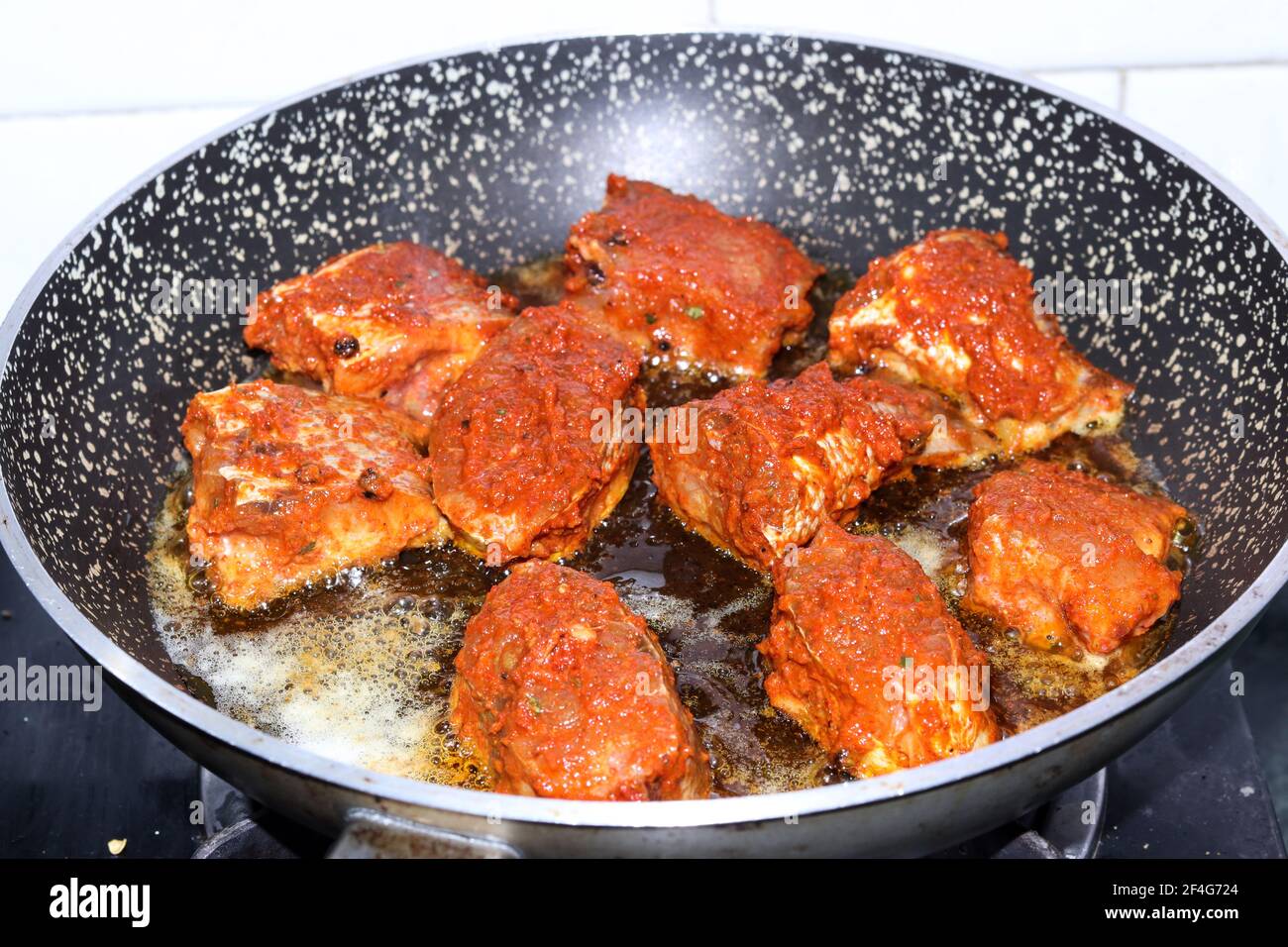 Healthy delicious fish is being fried in a pan; the best way to serve ...
