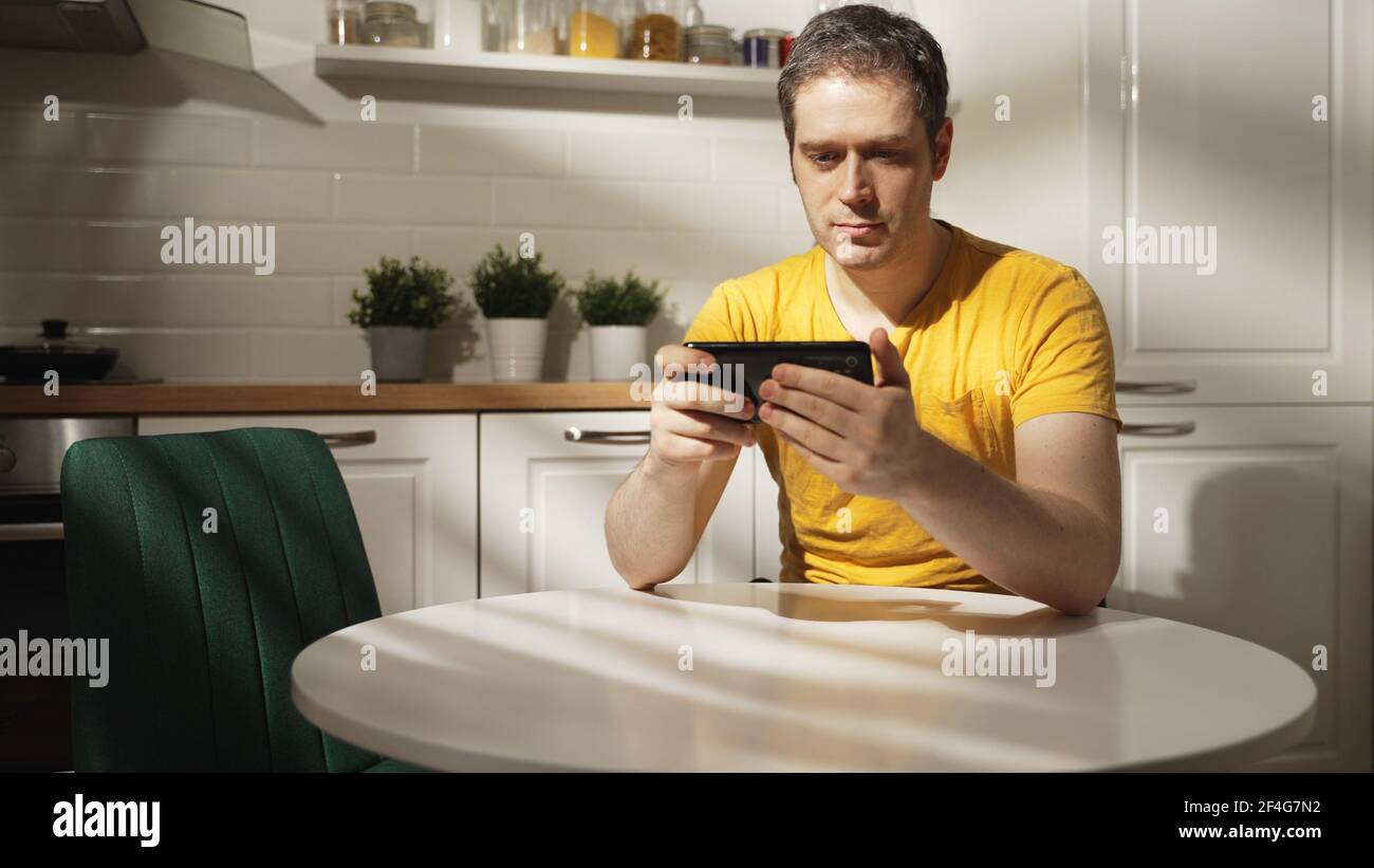 Man playing with his phone hi-res stock photography and images - Alamy