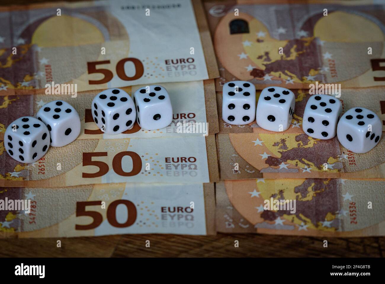 several white dice and euro money for game winnings and gambling that ...