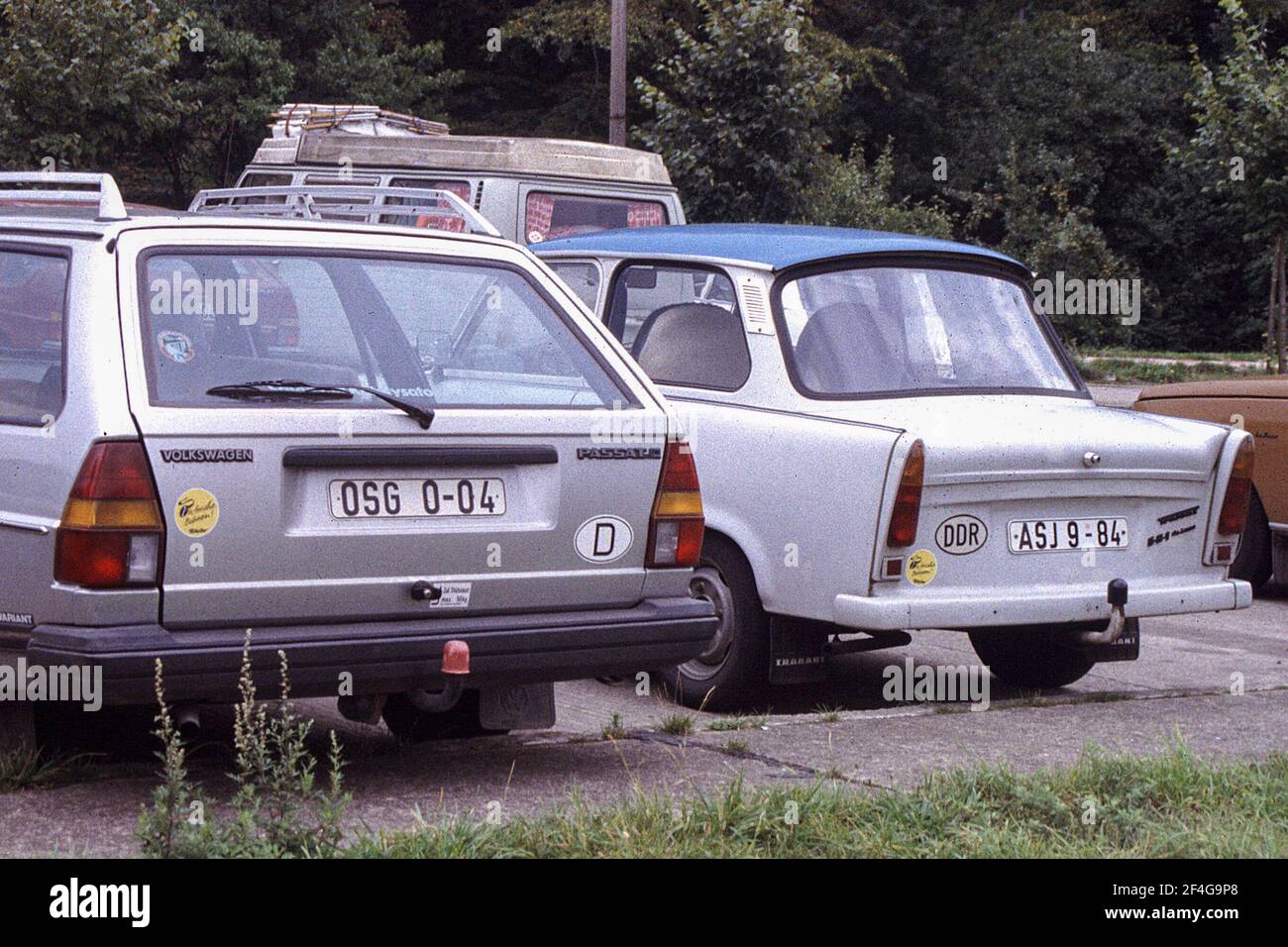 Two cars one with a West German sticker and the other with an East ...