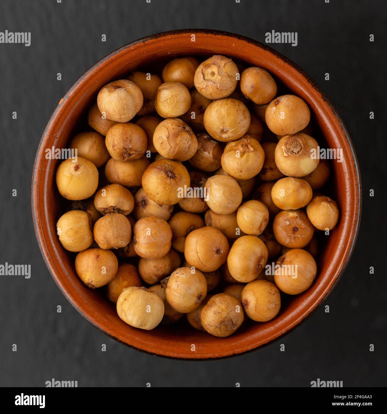 Whole dried bush onion (Afrostyrax lepidophyllus) in a bowl Stock Photo ...