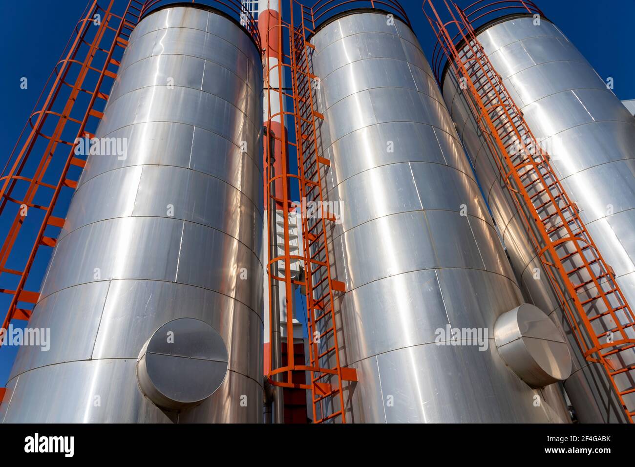 Oil Refinery Exterior with Oil Storage Tanks Over Blue Sky Background ...