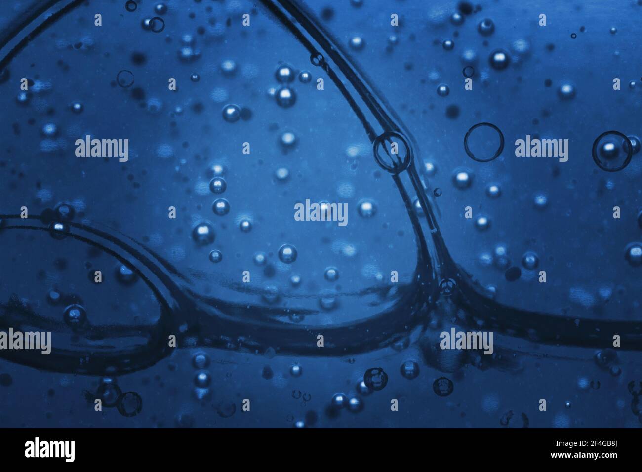 Blue liquid gel cosmetic smudge texture. View of microscope. Selective ...