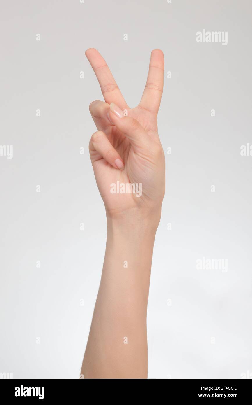 Peace hand gesture isolated on white background Stock Photo - Alamy