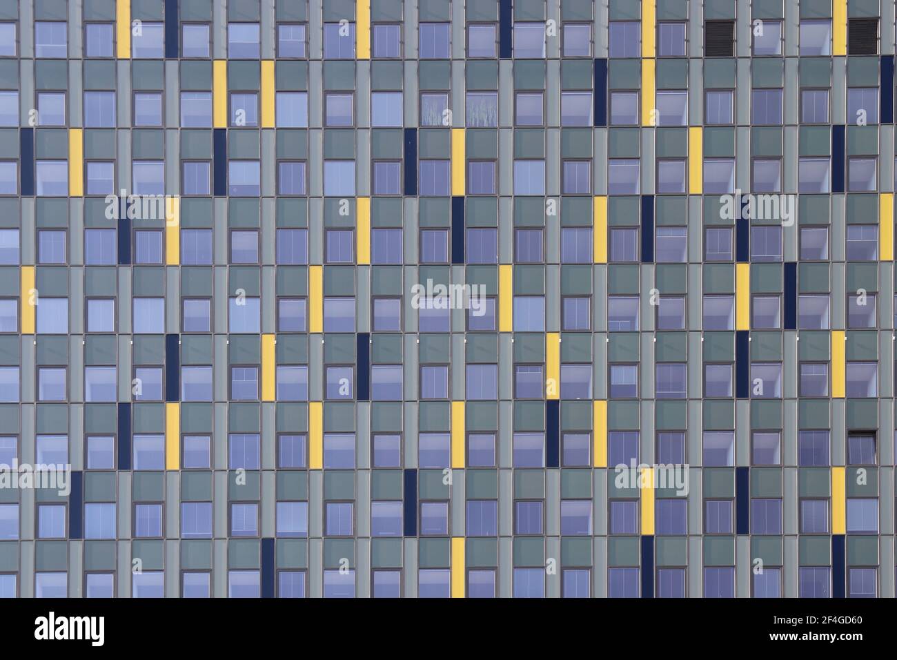 The facade of a modern glass building with blue and yellow details ...