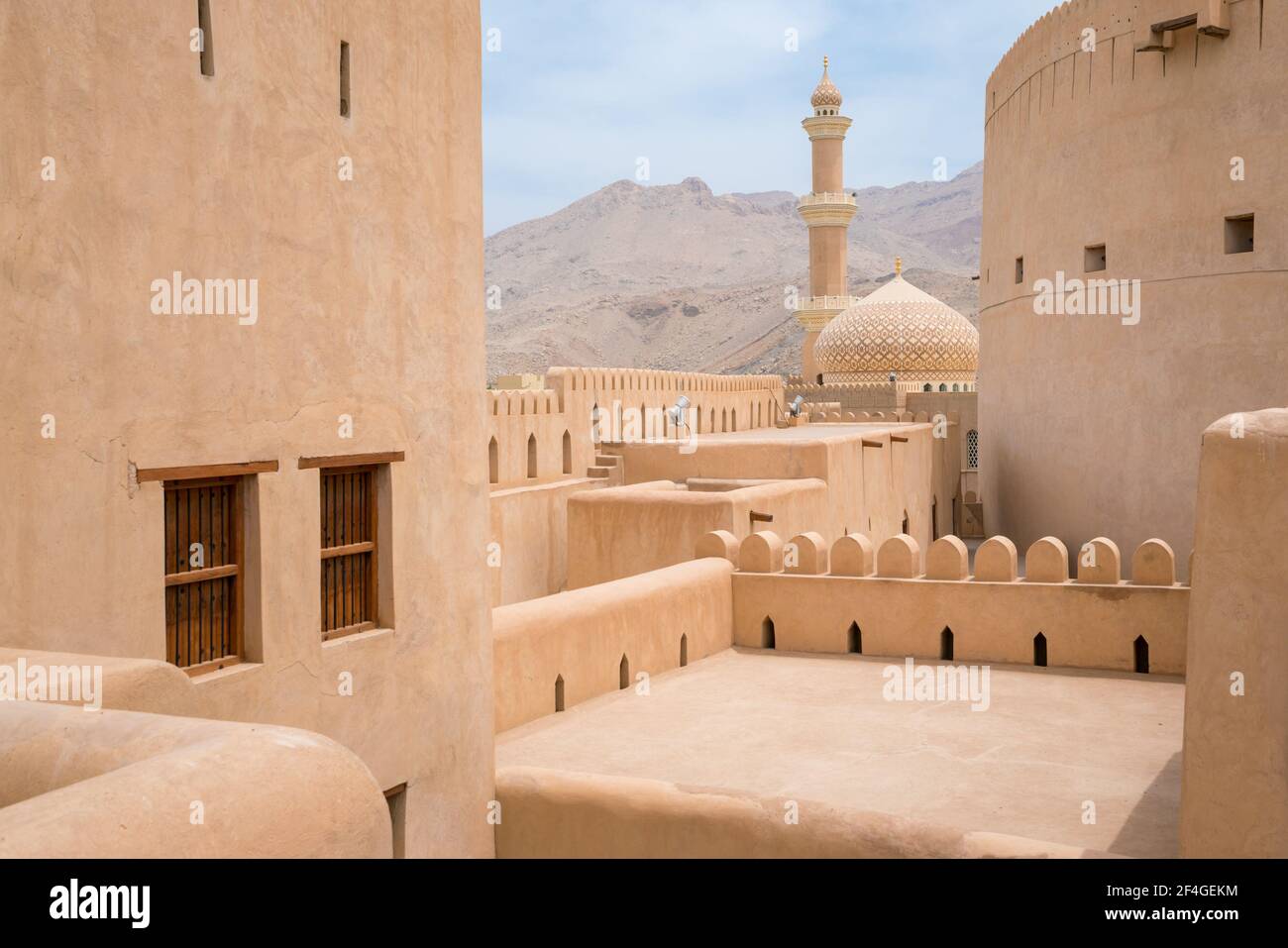 Minaret, dome and walls of medievel arabian fort of Nizwa, Oman. Hot ...