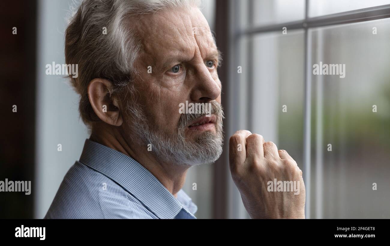 Worried nervous elderly man look at window wait for someone Stock Photo ...