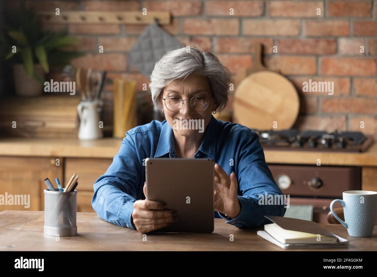 Old age grandmother enjoy reading e book on tablet pc Stock Photo - Alamy