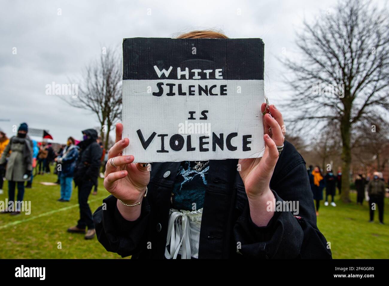 A protester holds an anti racist placard during the demonstration.On ...