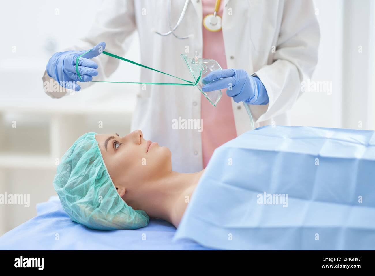 Nurse gives respiratory therapy to a patient recovering in the hospital ...