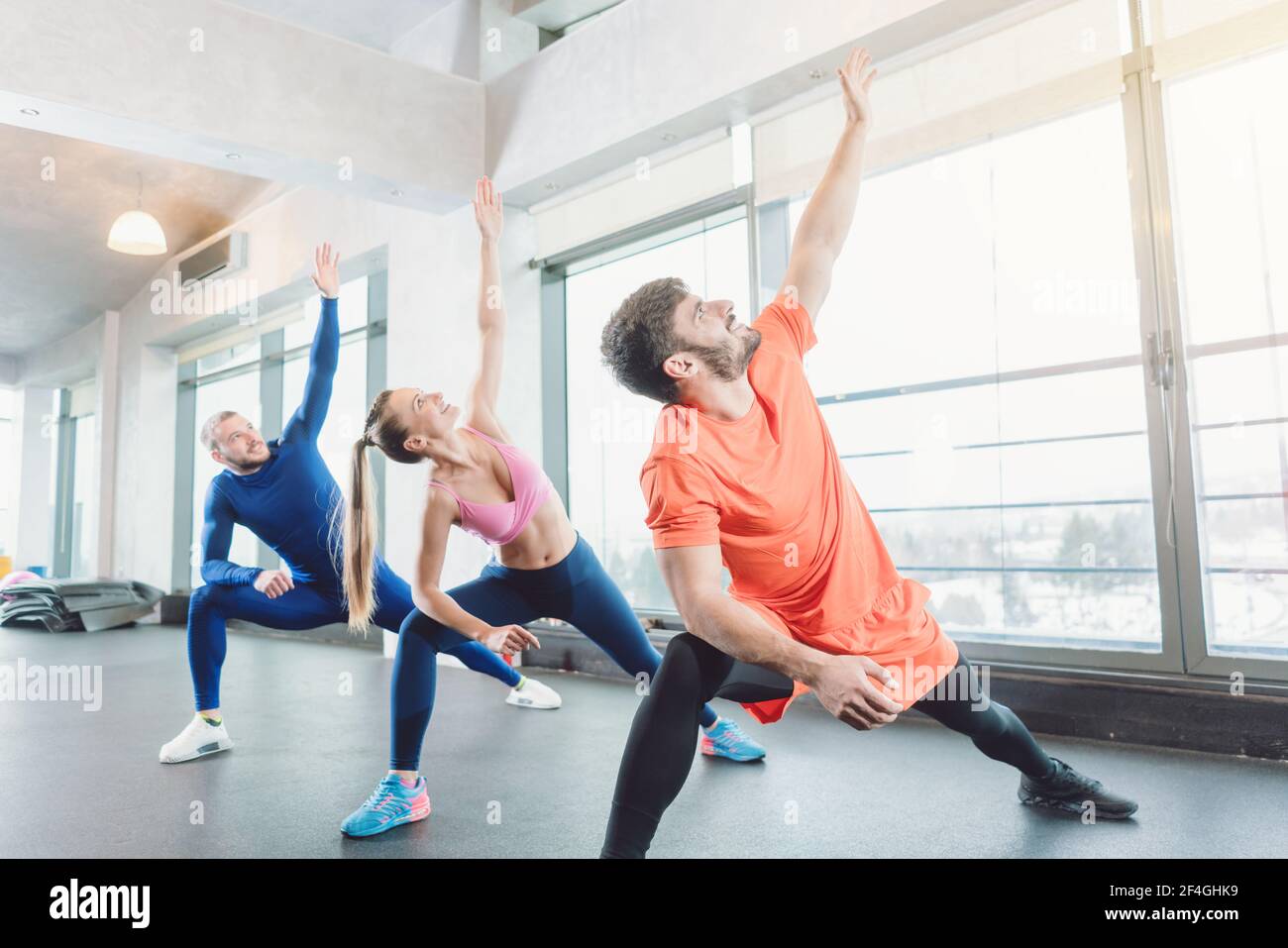 Fitness class in a modern gym with people stretching Stock Photo - Alamy