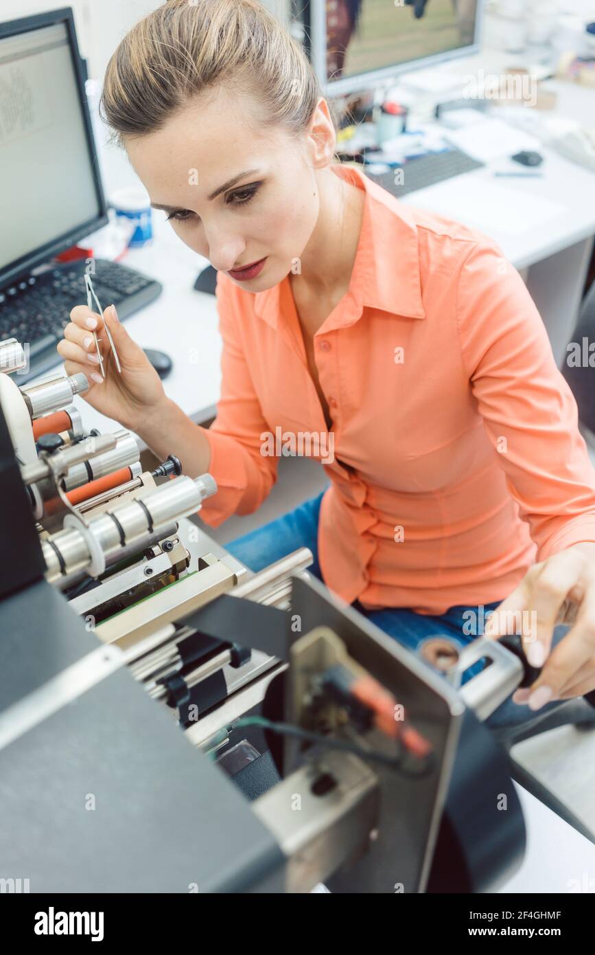Worker woman putting new labels in printing machine Stock Photo - Alamy