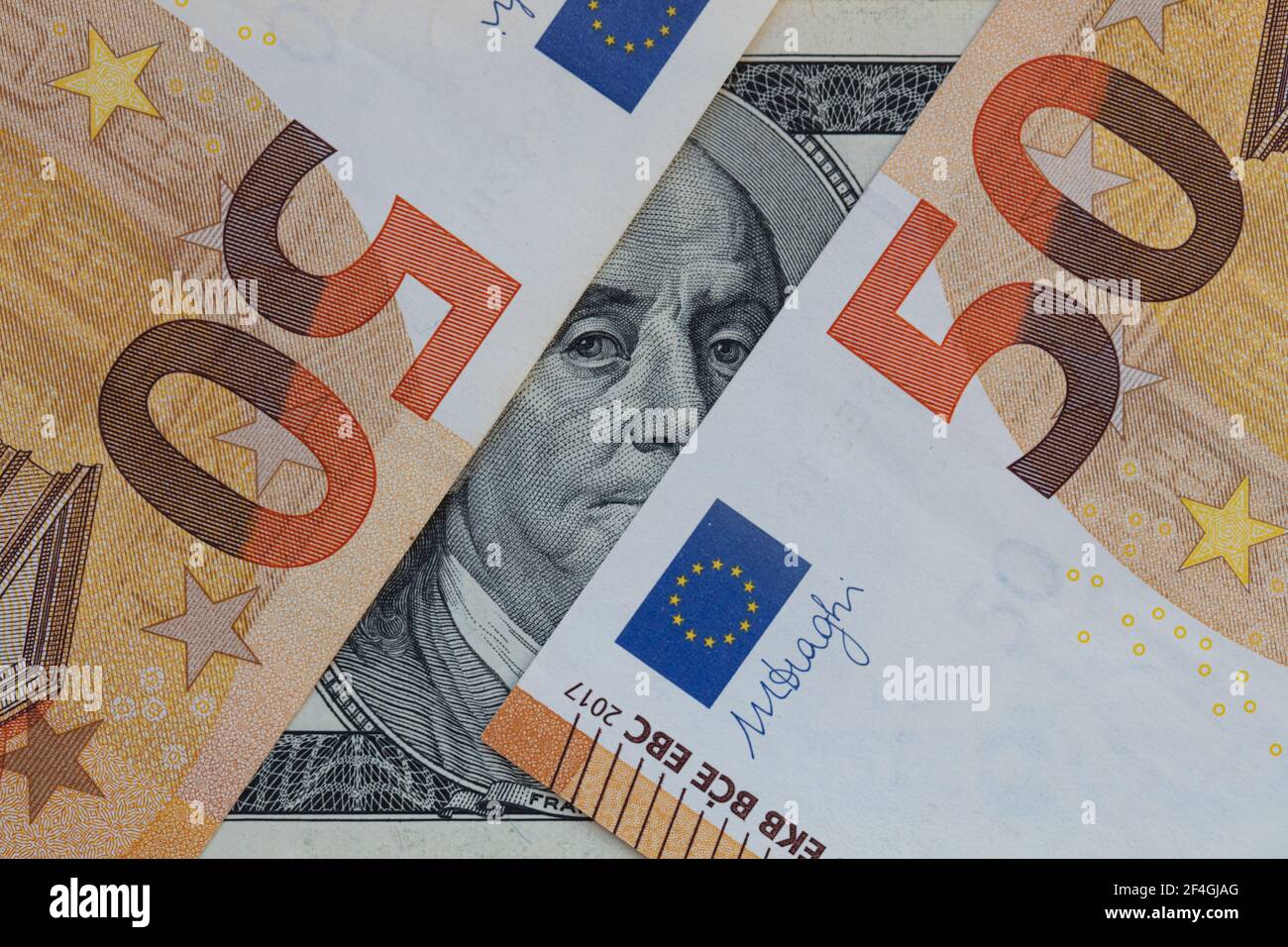 Benjamin Franklin peeking through 50 euro banknotes for design purpose ...