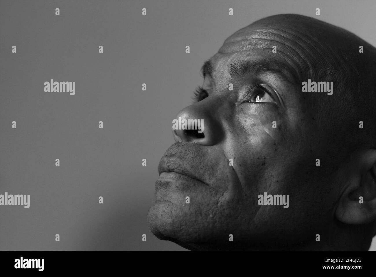 man praying to god with eyes open Caribbean man praying with white ...