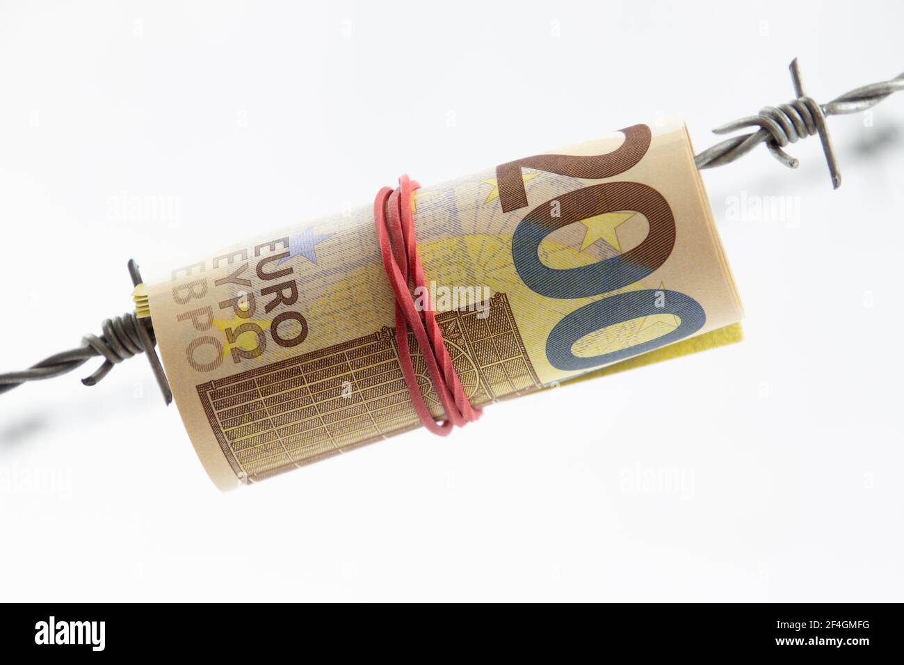 200 euro bank notes rolled up and hanging on barbed wire Stock Photo ...