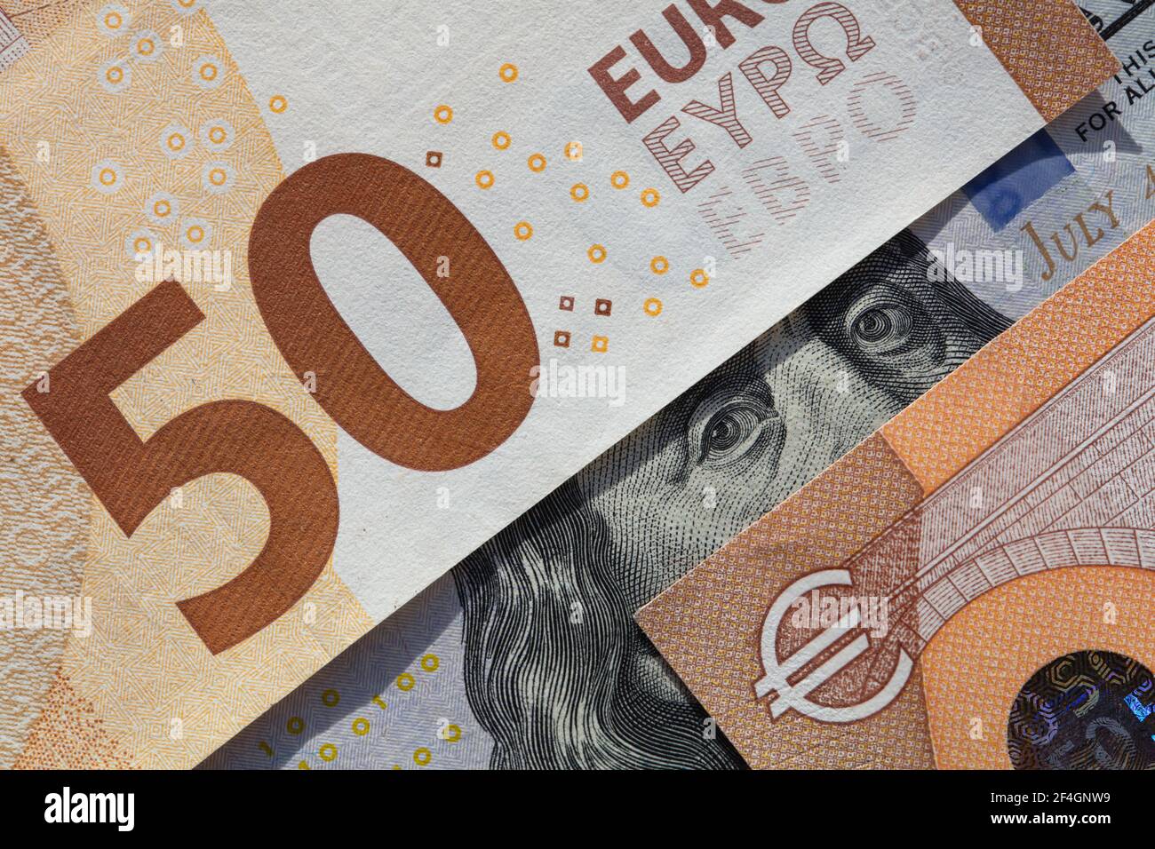 Benjamin Franklin peeking through 50 euro banknotes for design purpose ...