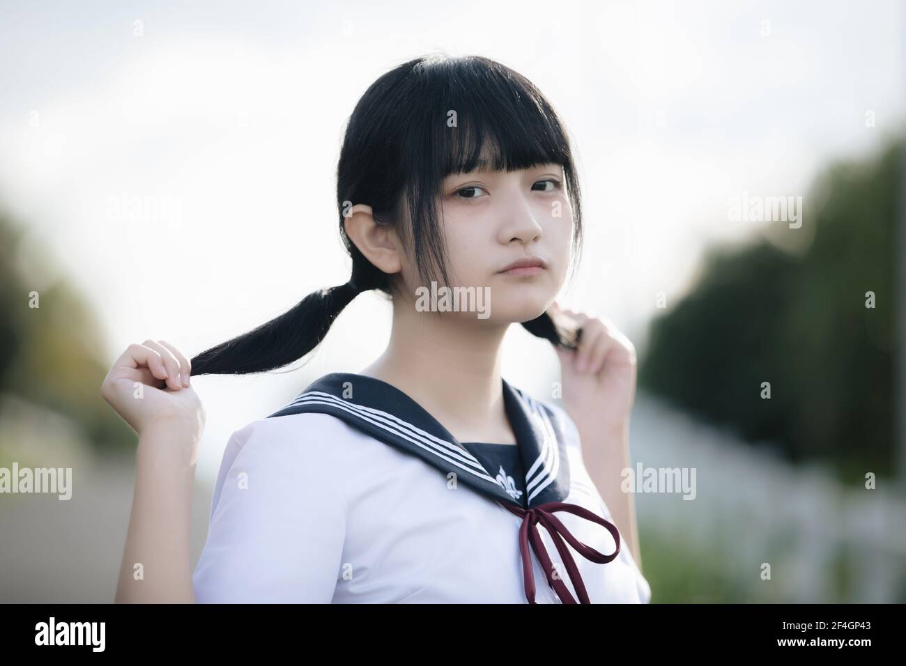 Portrait Of Asian Japanese School Girl Costume Looking At Park Outdoor Film Vintage Style Stock