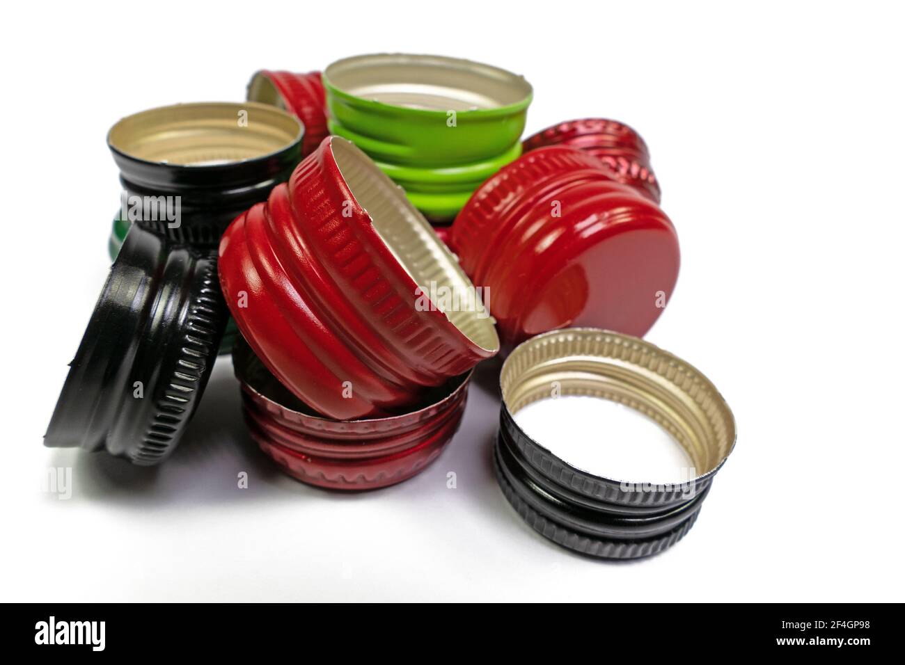 Old aluminum bottle caps against a white background Stock Photo - Alamy
