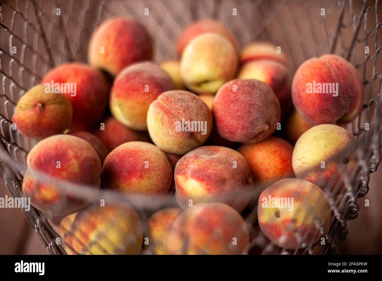 Fresh peaches fruits in basket close-up. Selective focus, top view ...