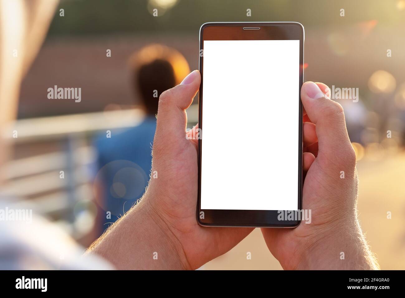 Man uses his Mobile Phone outdoor, close up. Mockup image blank white ...