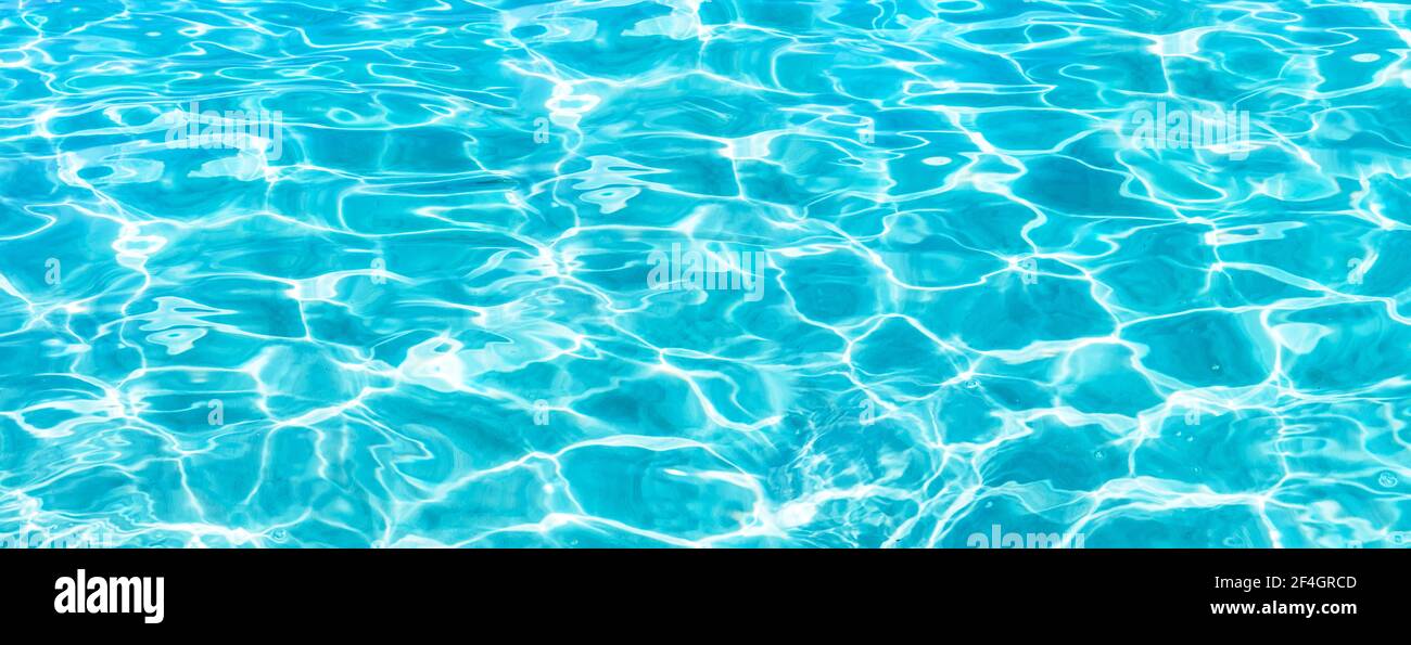 Shining blue water ripple background. Surface of water in swimming pool ...