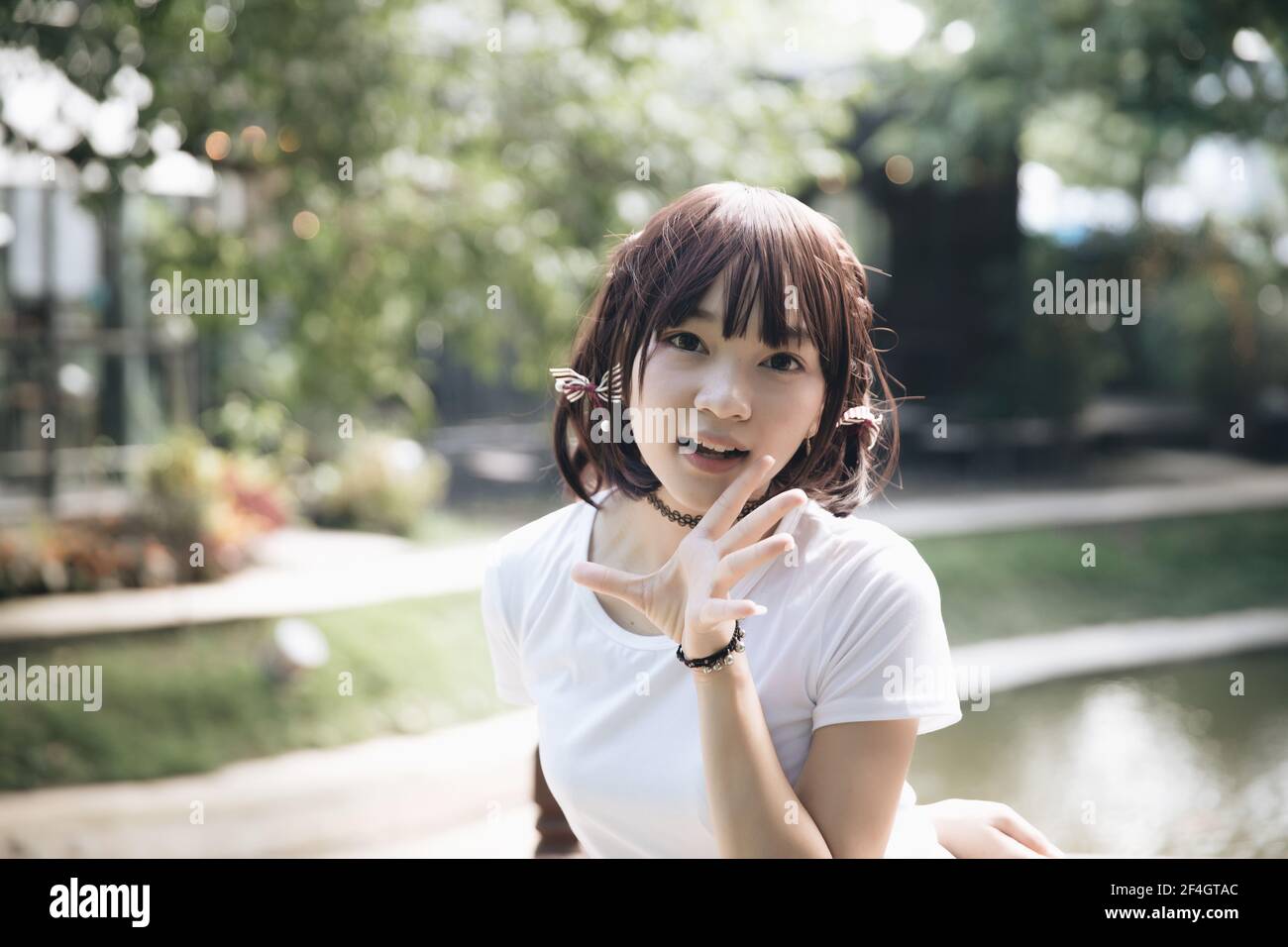 portrait of asian girl with white shirt and skirt looking in outdoor ...
