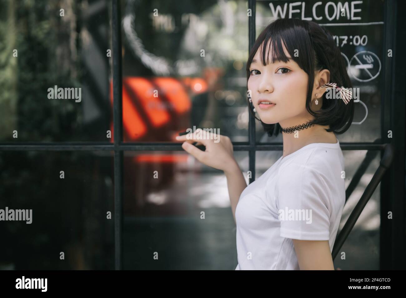 portrait of asian girl with white shirt and skirt looking in outdoor ...