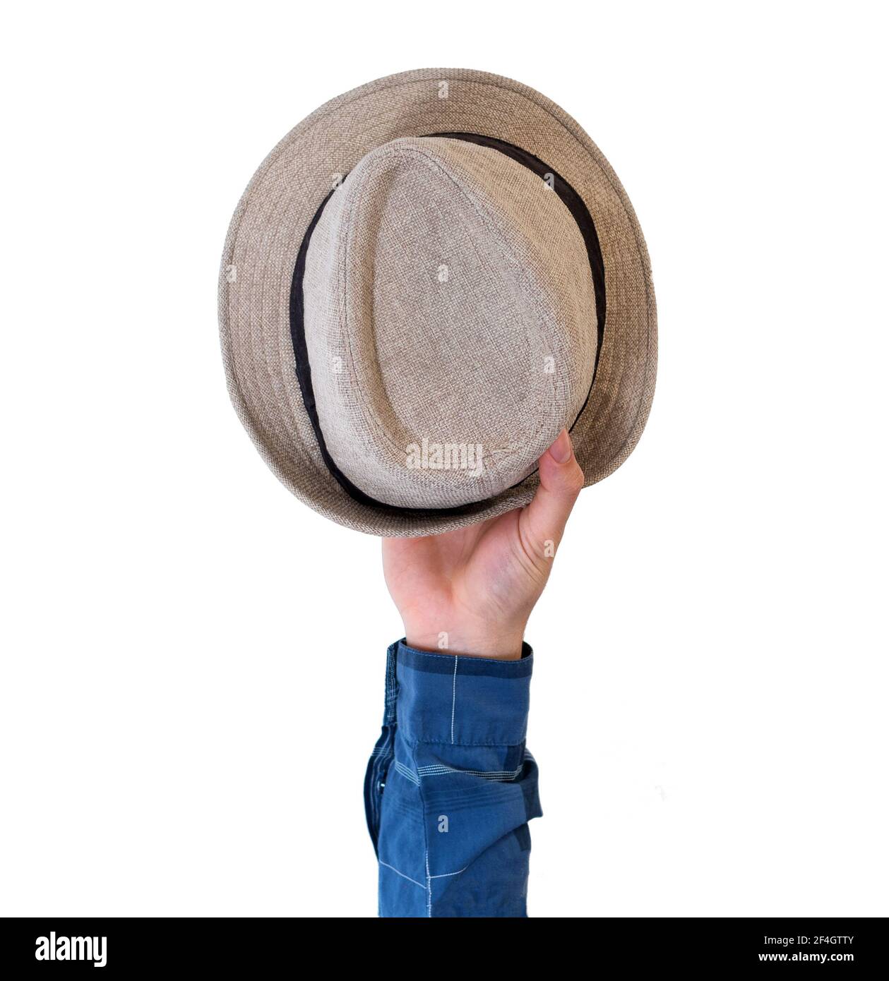 A person's raised arm holding a brown hat isolated on a white ...
