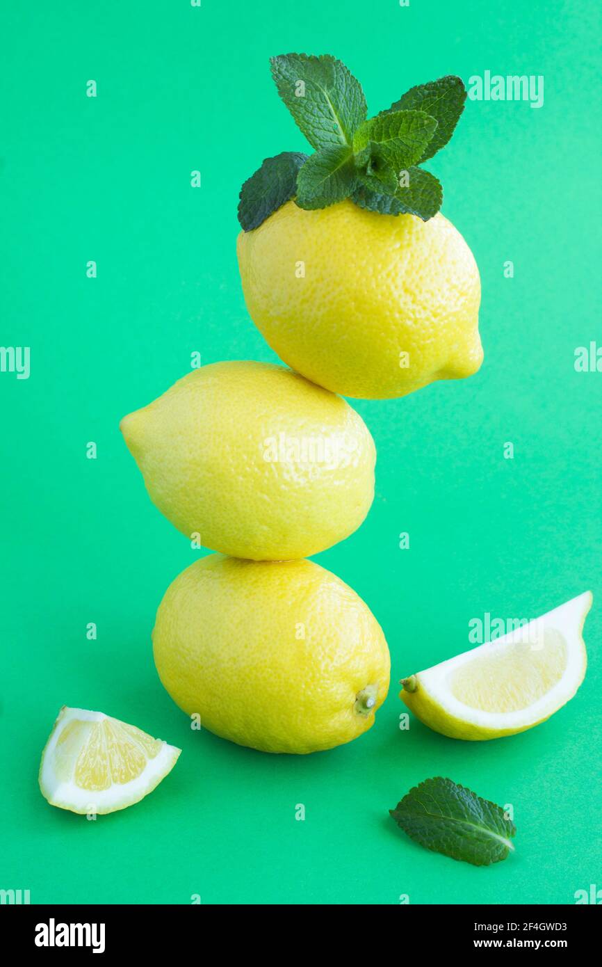 Lemons stacked pyramid on the green background. Location vertical Stock ...