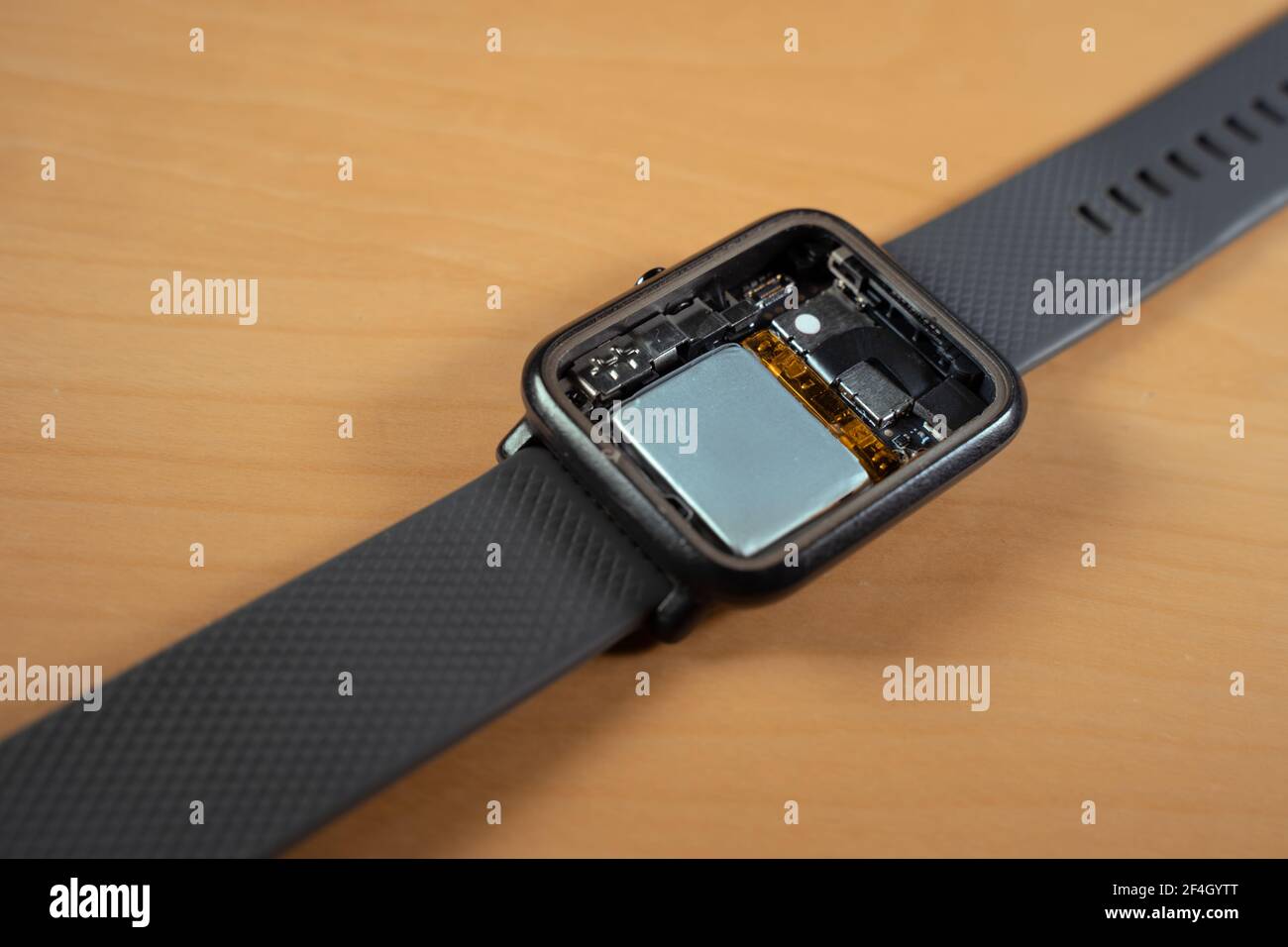 Disassembled smartwatch showing the interior, battery, different ...