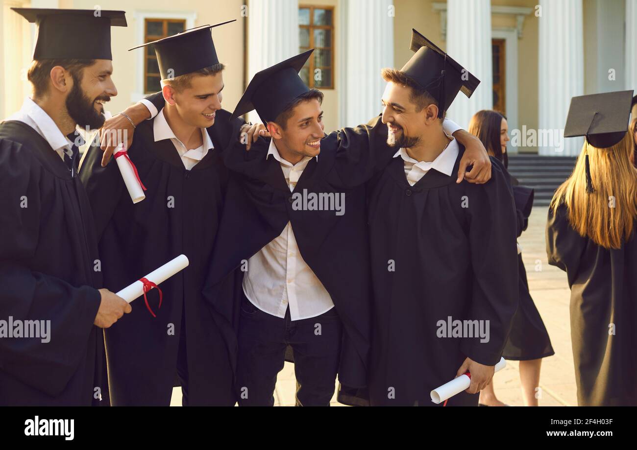 Group of happy boys students university graduates mates standing and ...