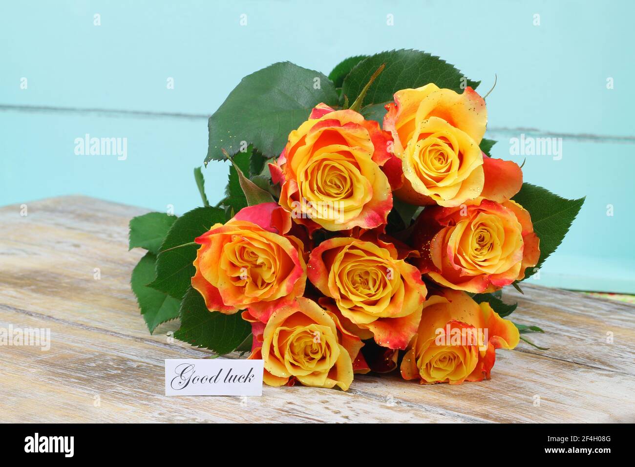 Good luck card with colorful rose bouquet on rustic wooden surface ...