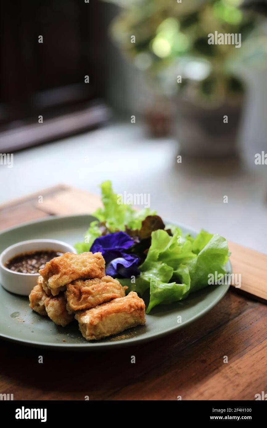 Vegan food appetizer japanese fried tofu on wood background vintage ...