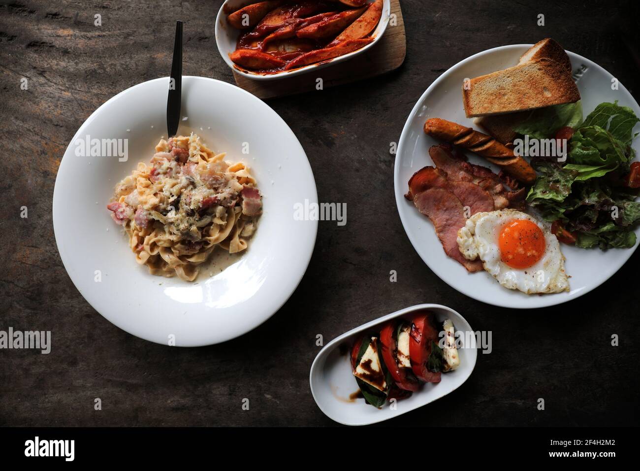 food flat lay top view with pasta and english breakfast on wood ...
