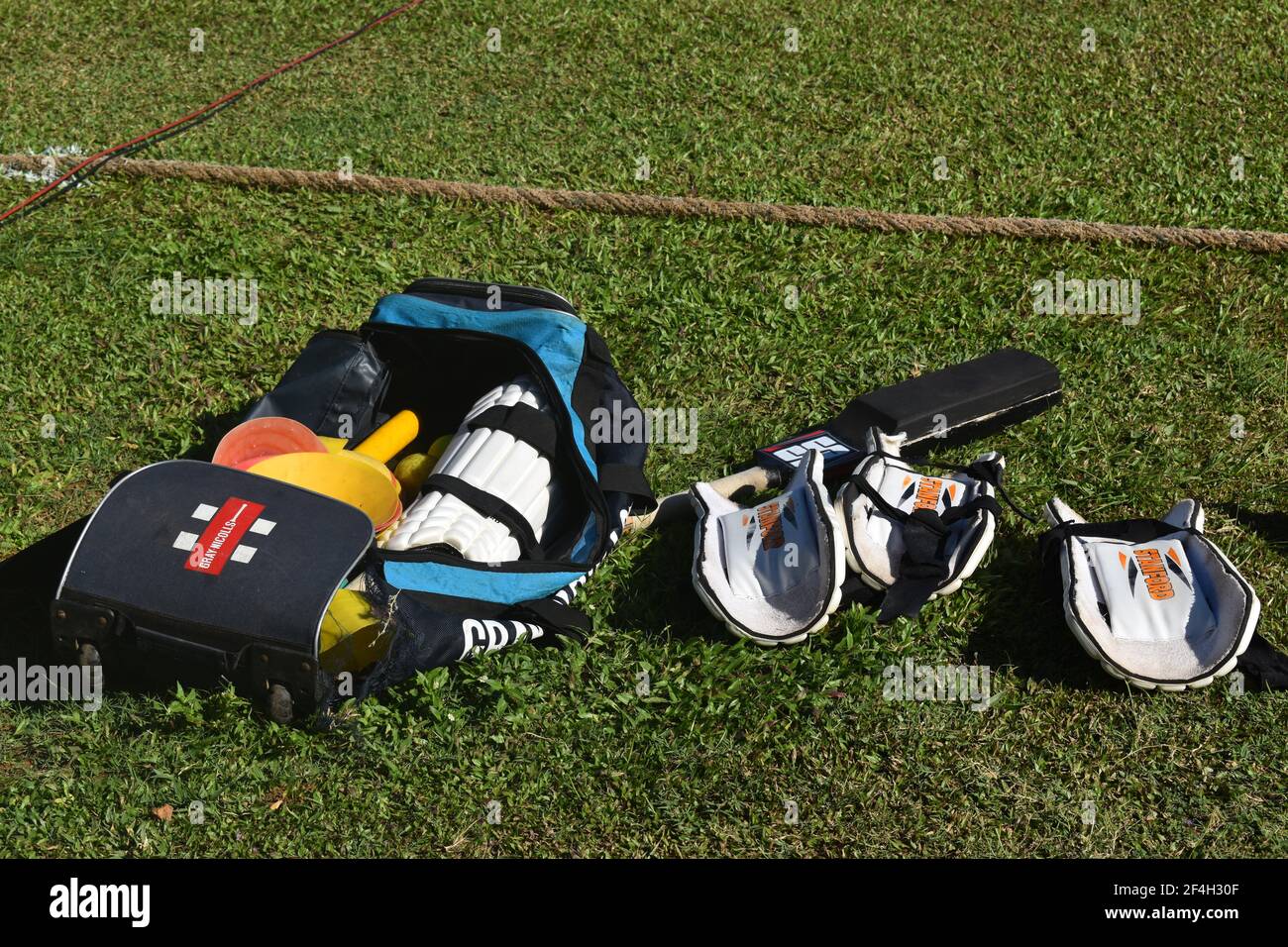 Cricket gear kept on the ground in the sun during a match. Colombo, Sri ...