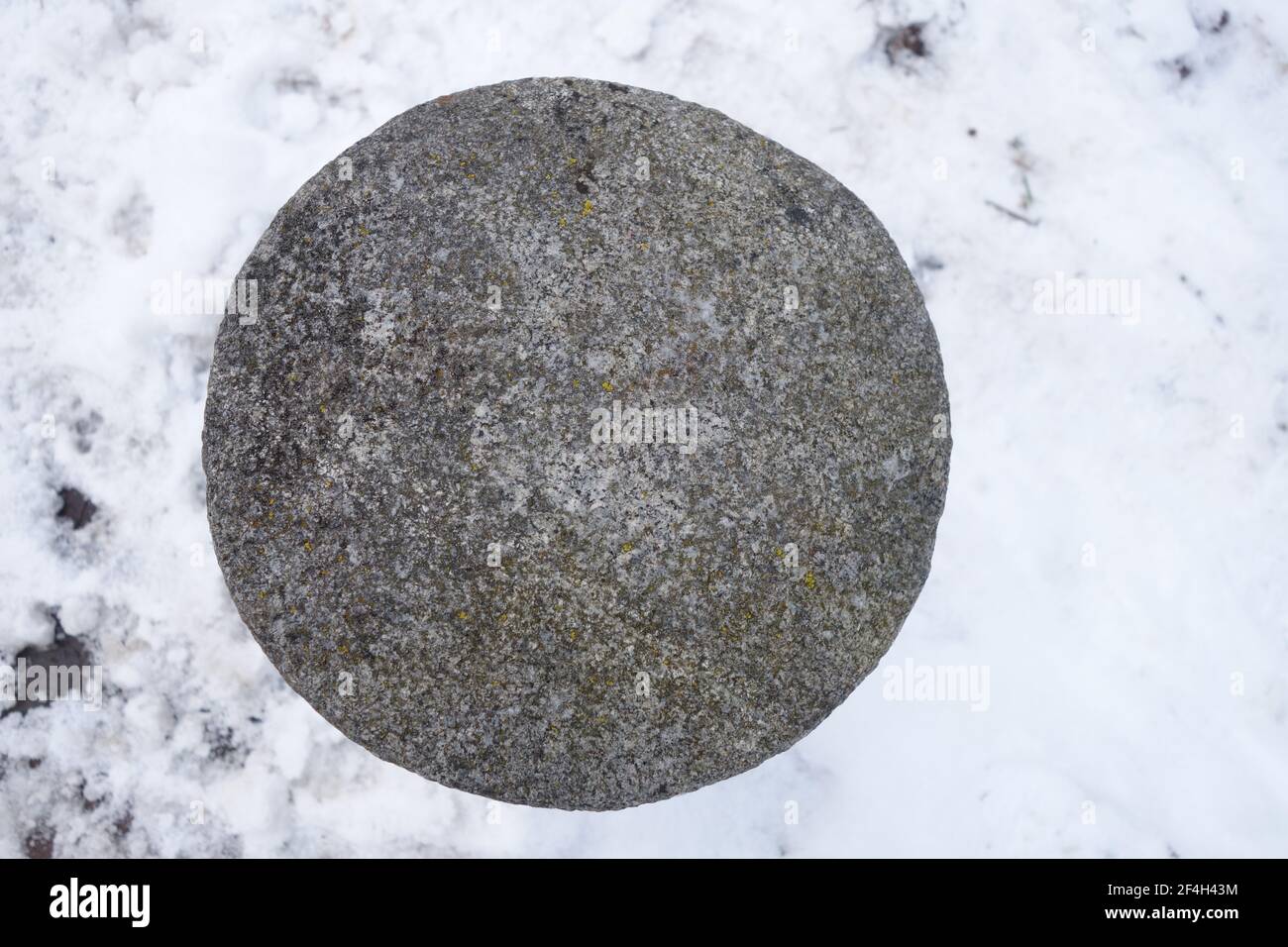An overhead shot of a piece of rock on a snowy surface Stock Photo - Alamy