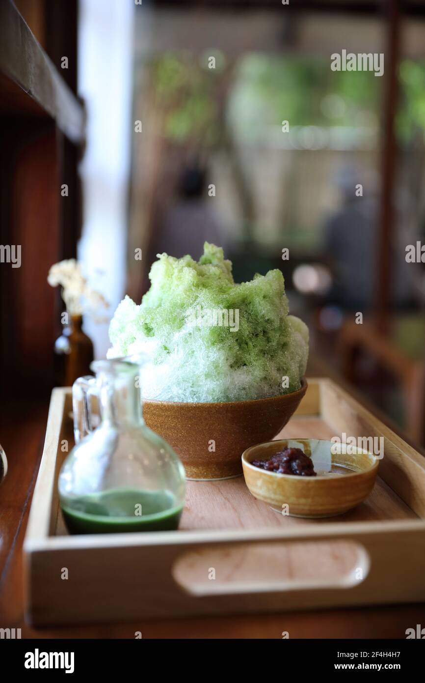 Delicious Japanese sweet shaved ice green tea on wooden table in ...